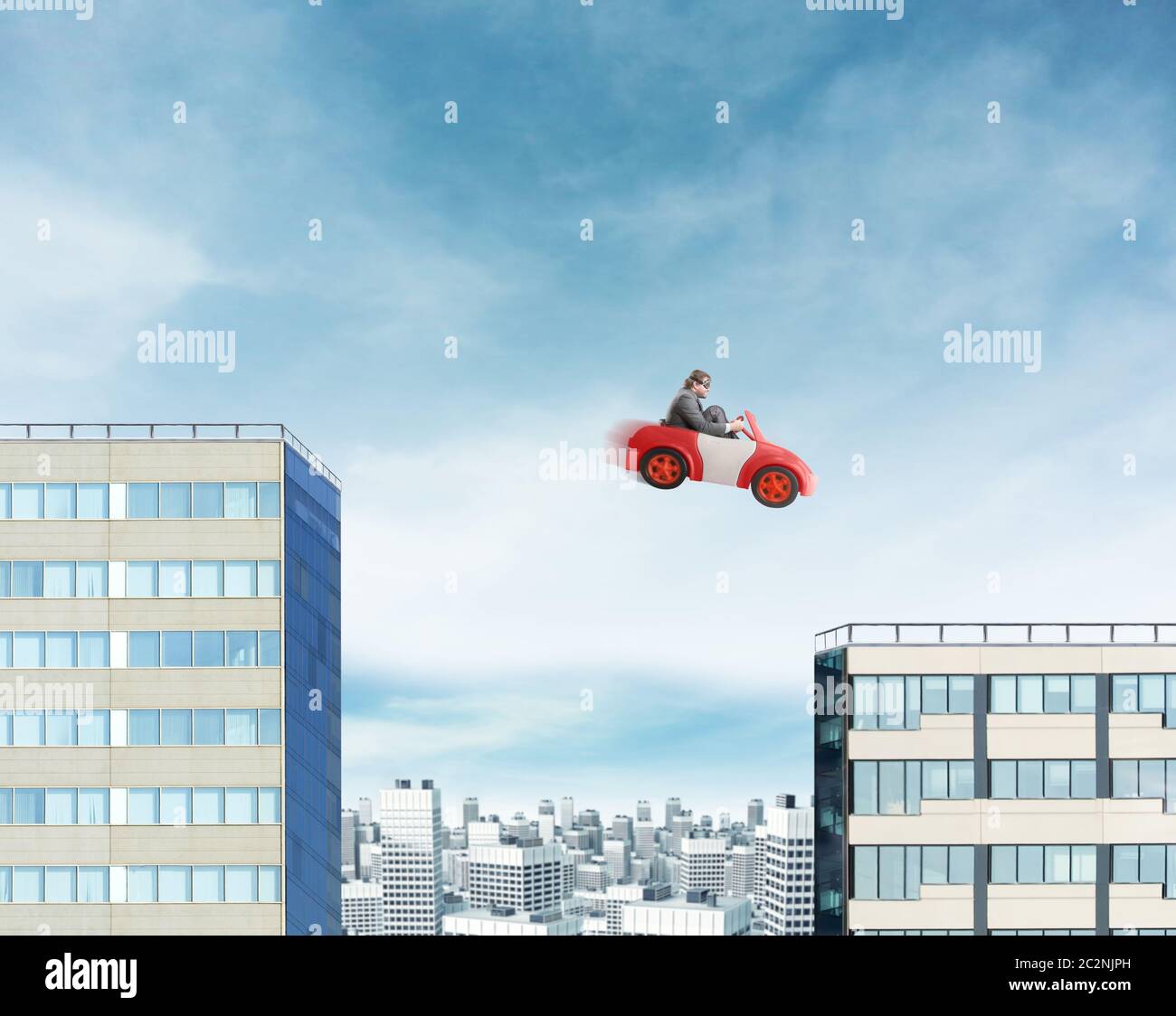 Young businessman driving car jumping between two high buildings Stock ...