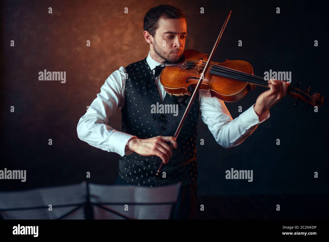 Male violinist playing classical music on violin. Fiddler man with ...