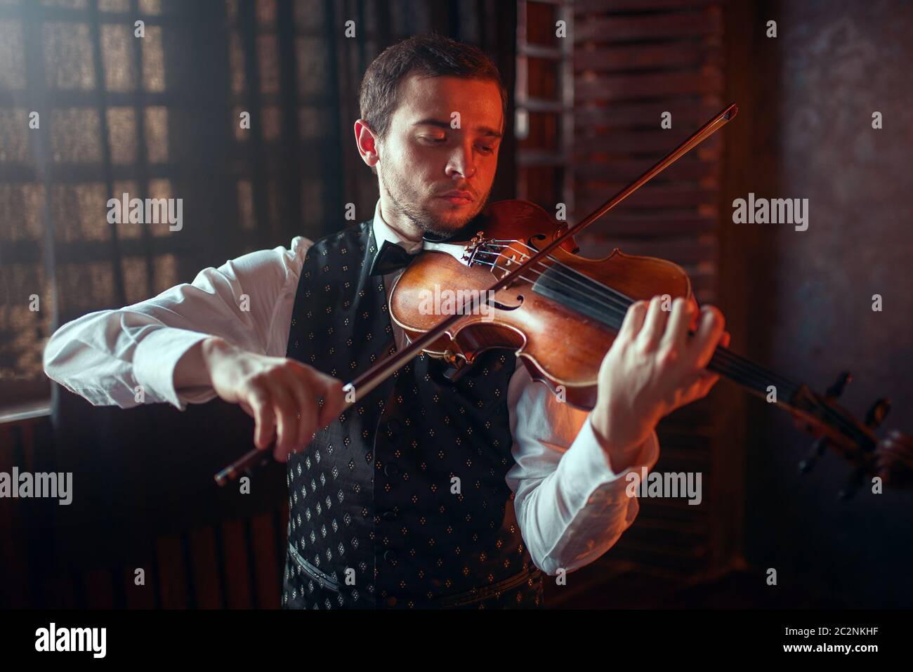 Male violinist playing classical music on violin. Fiddler man with ...