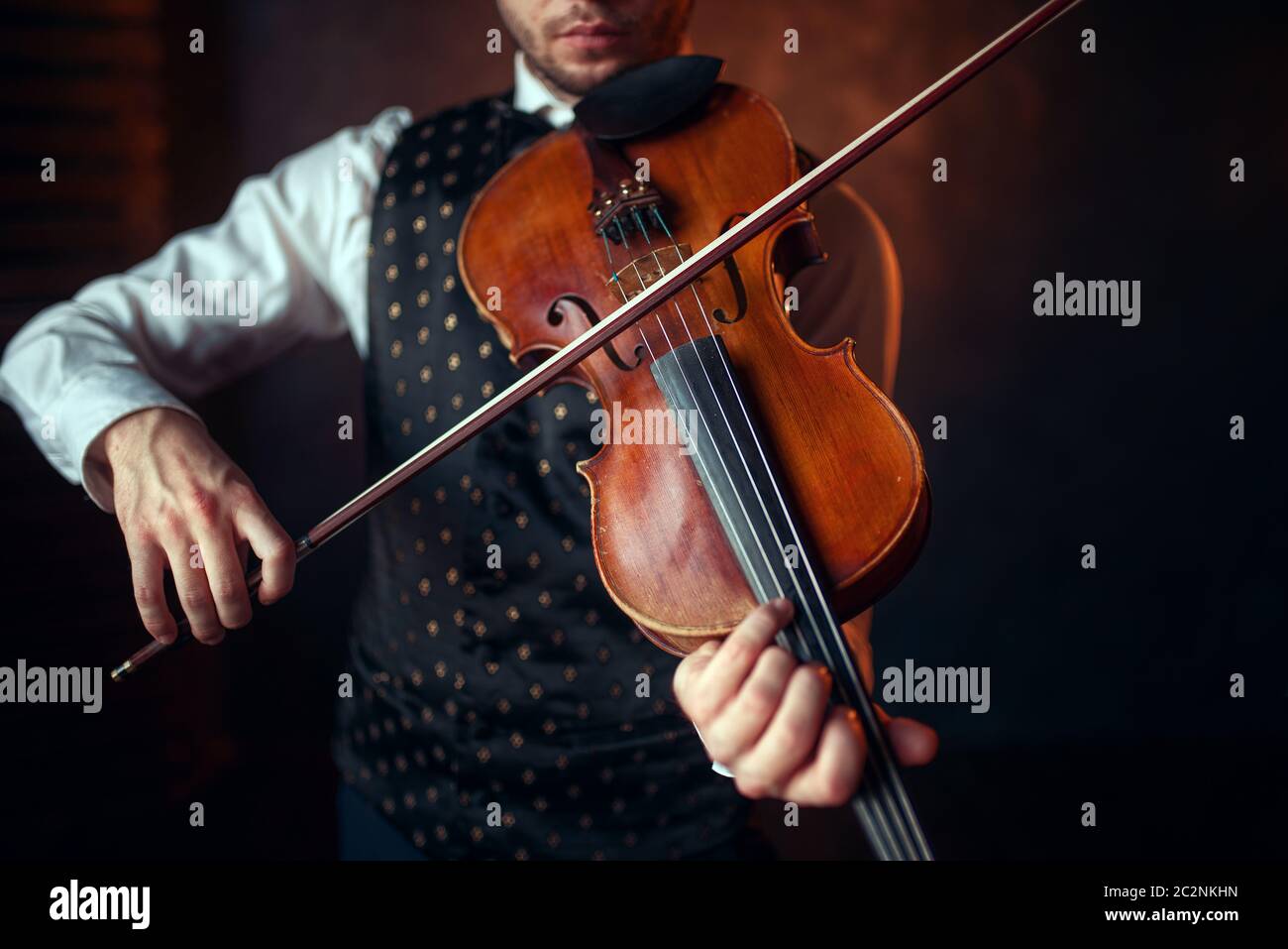 Male violinist playing classical music on violin. Fiddler man with ...