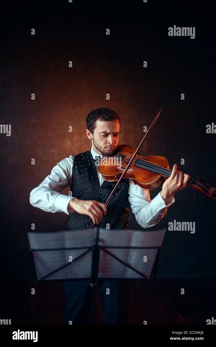 Male violinist playing classical music on violin. Fiddler man with ...