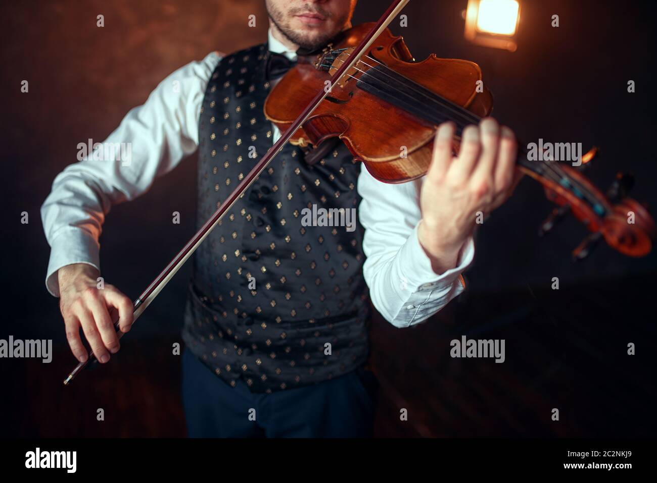 Portrait of male fiddler playing classical music on violin. Violinist ...