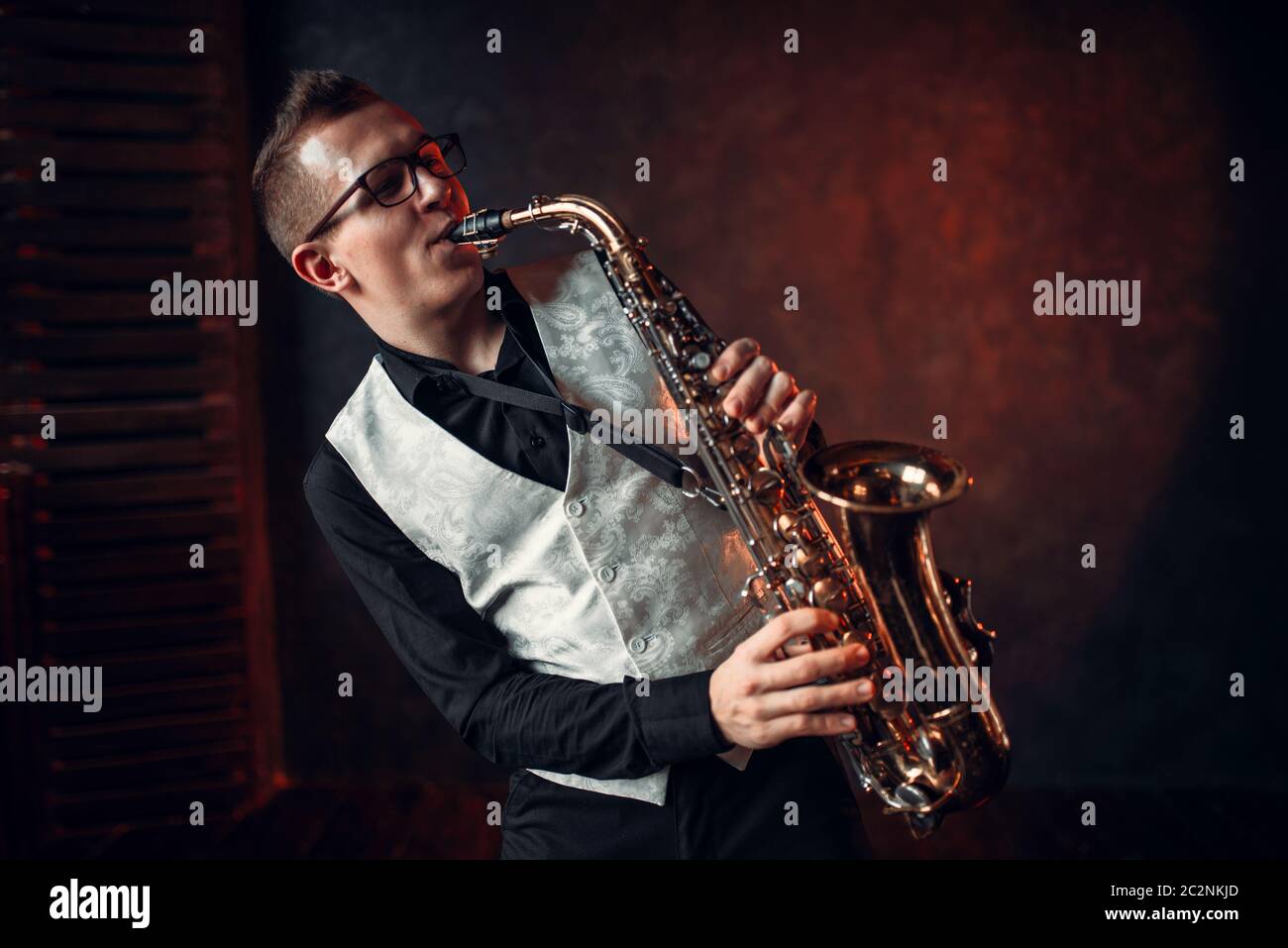 Male saxophonist playing classical jazz melody on sax. Jazz-man concept ...