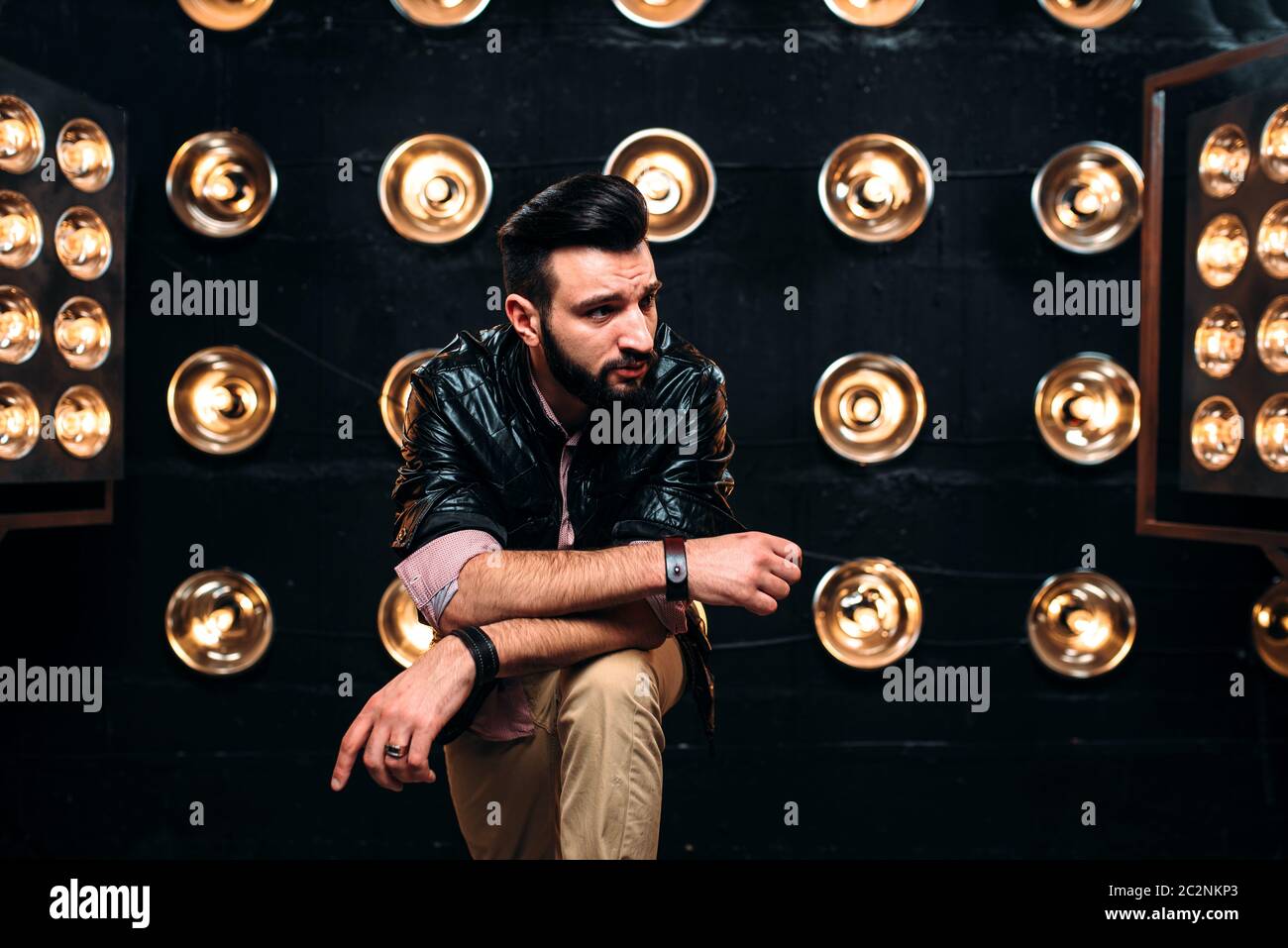 Bearded singer in black leather jacket on the stage with the ...