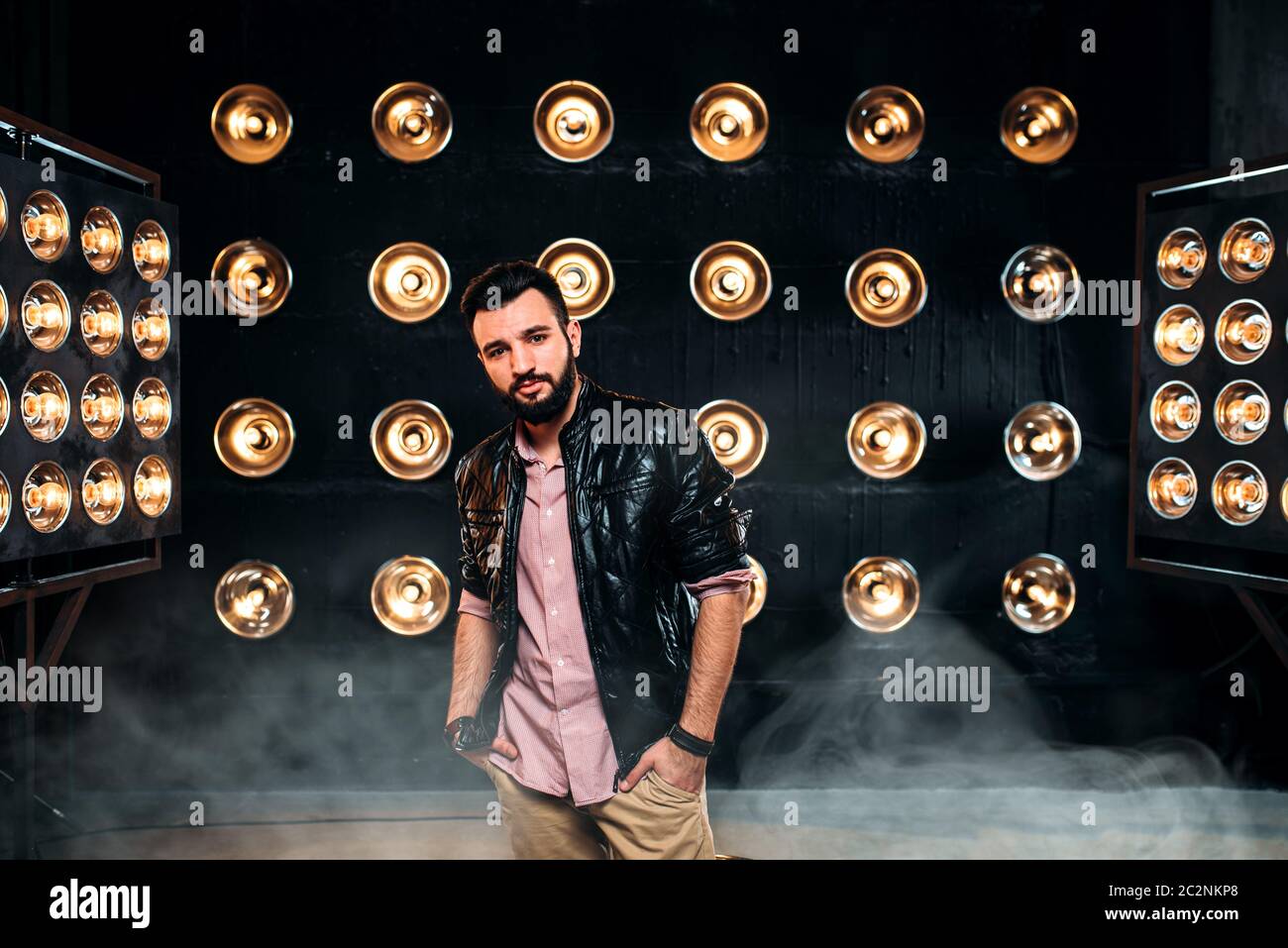 Bearded singer in black leather jacket on the stage with the ...