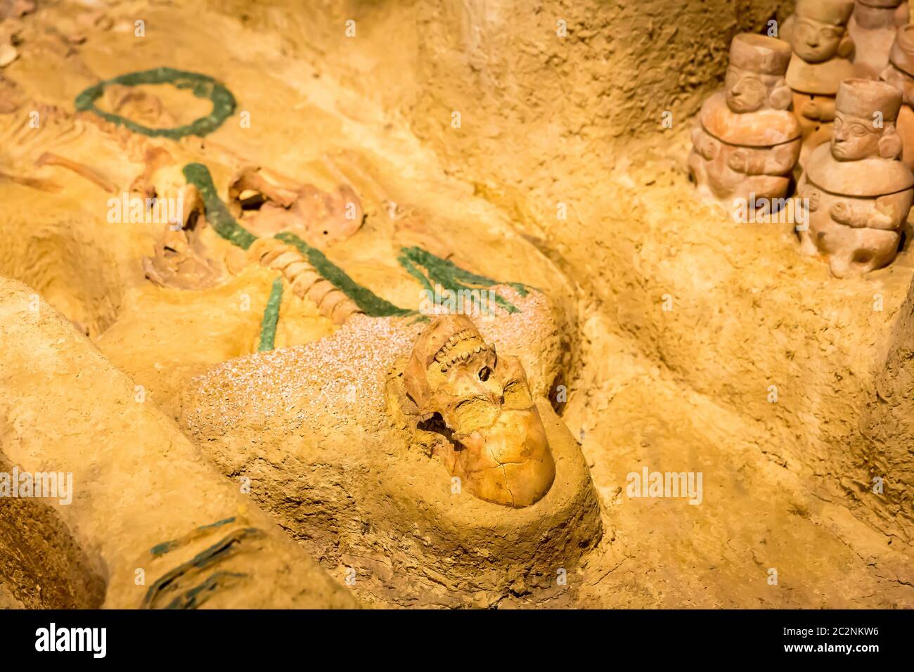 Archeological excavations of human burial. Figure and figurines on the ...