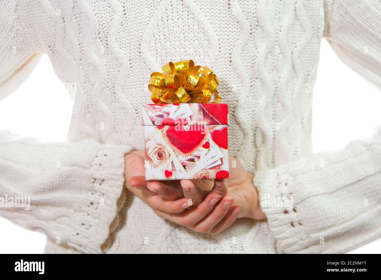 Valentine's Day gift in palms of hands behind the back Stock Photo - Alamy