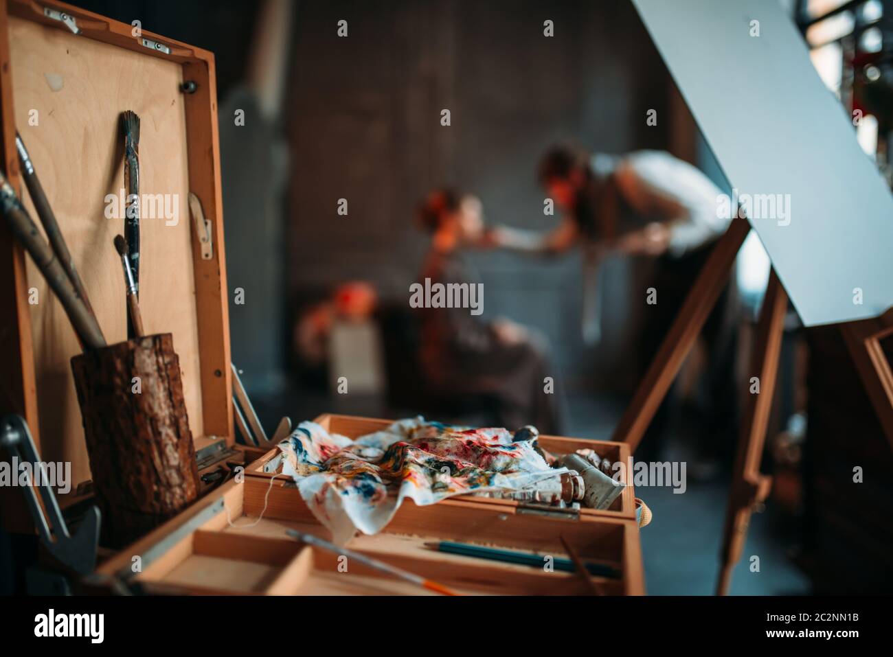 Wooden sketch drawer with drawing tools closeup view. Male painter work ...