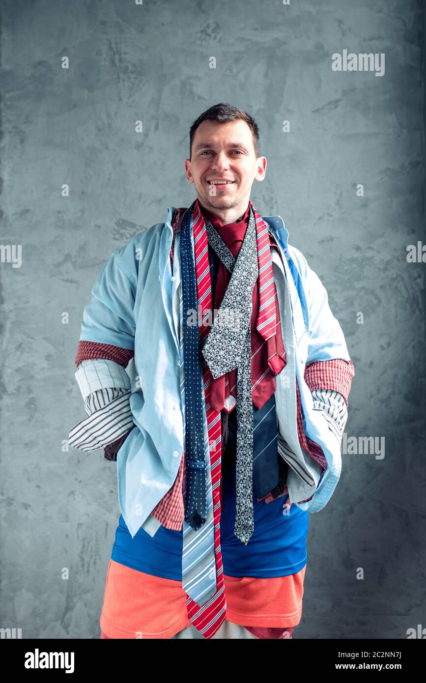 Man dressed in many clothes. Shopping concept Stock Photo - Alamy