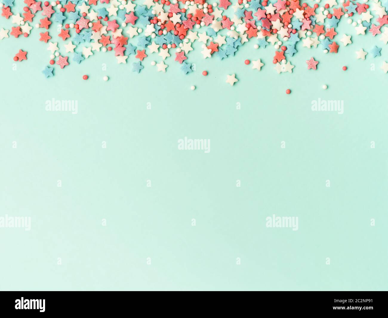 Festive border frame of colorful pastel sprinkles on blue background ...