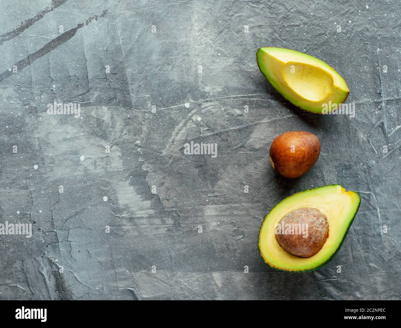 Avocado with copy space. Top view of avocado half, quarter and avocado ...