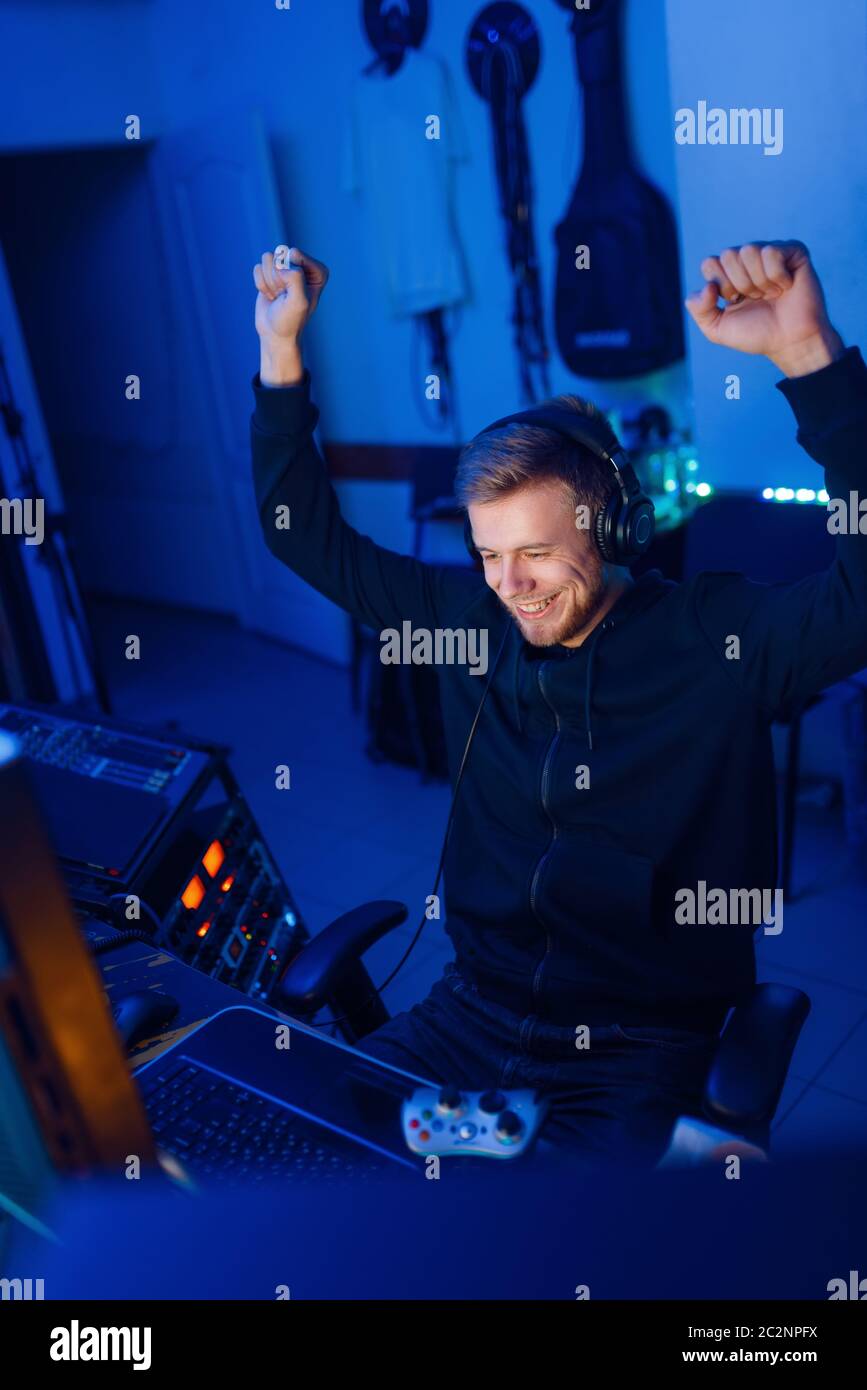 Male gamer with raised hands, tournament winner, gaming lifestyle ...