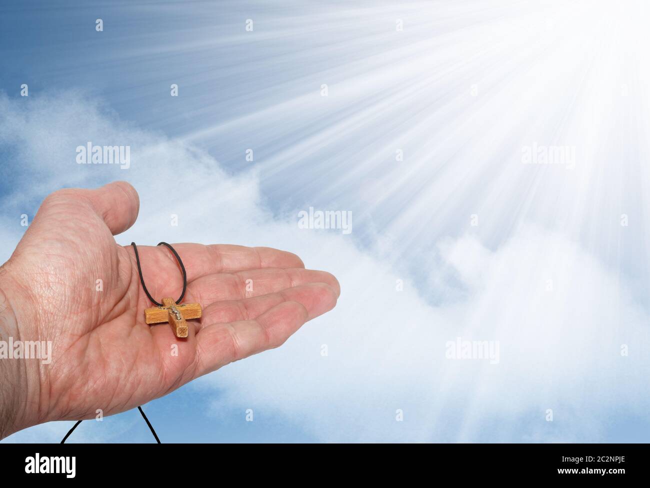 Hand with a wooden cross Stock Photo - Alamy