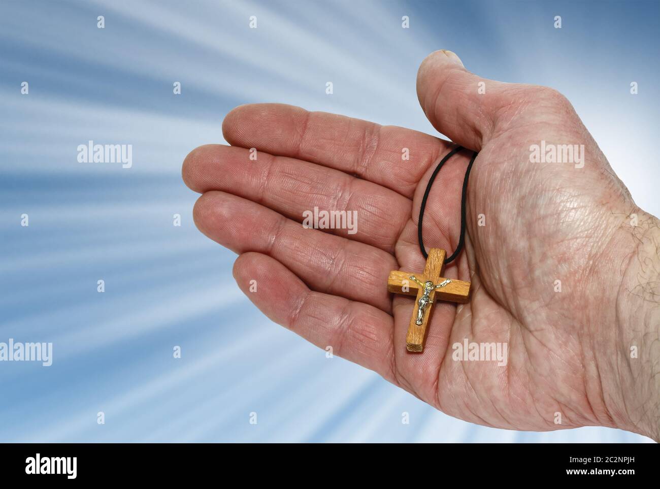 Hand with a wooden cross Stock Photo - Alamy