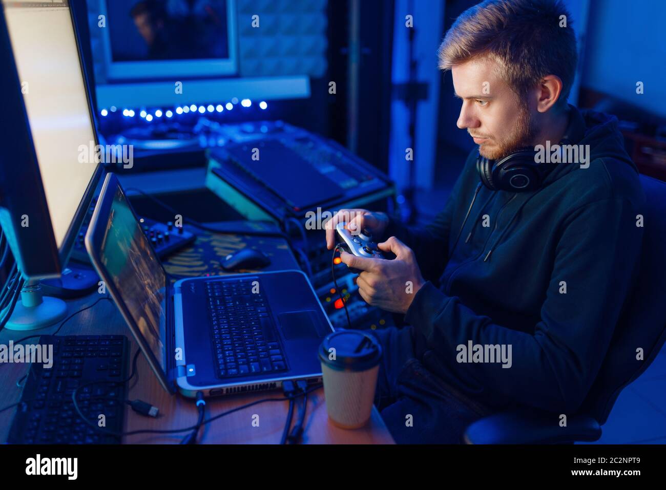 Male gamer in headphones holds joystick and playing videogame on ...