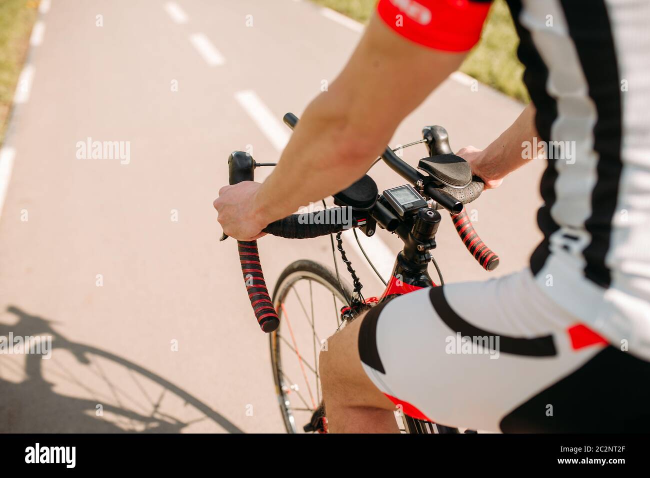 Male cyclist in sportswear, cycling on asphalt road. Male sportsman ...