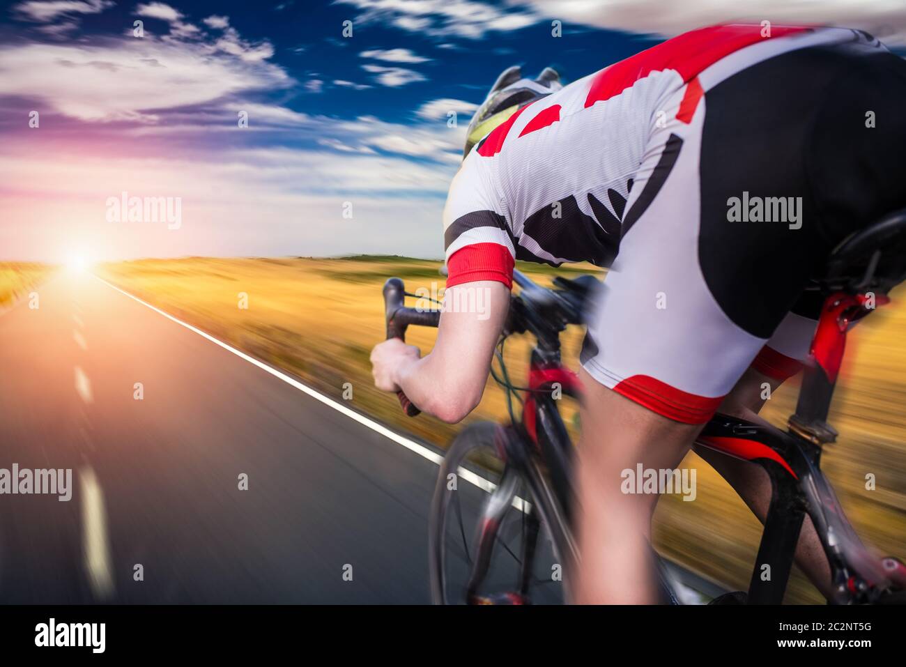 Cyclist in helmet and sportswear rides on bicycle, speed effect, back ...