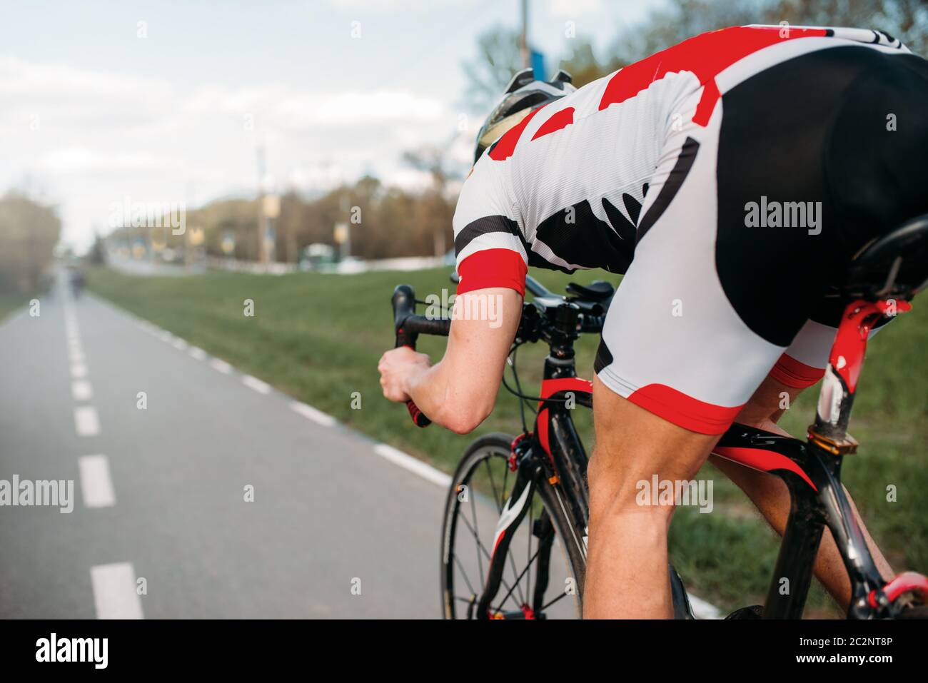 Male cyclist on bike path, view from the rear wheel. Cycling on asphalt ...