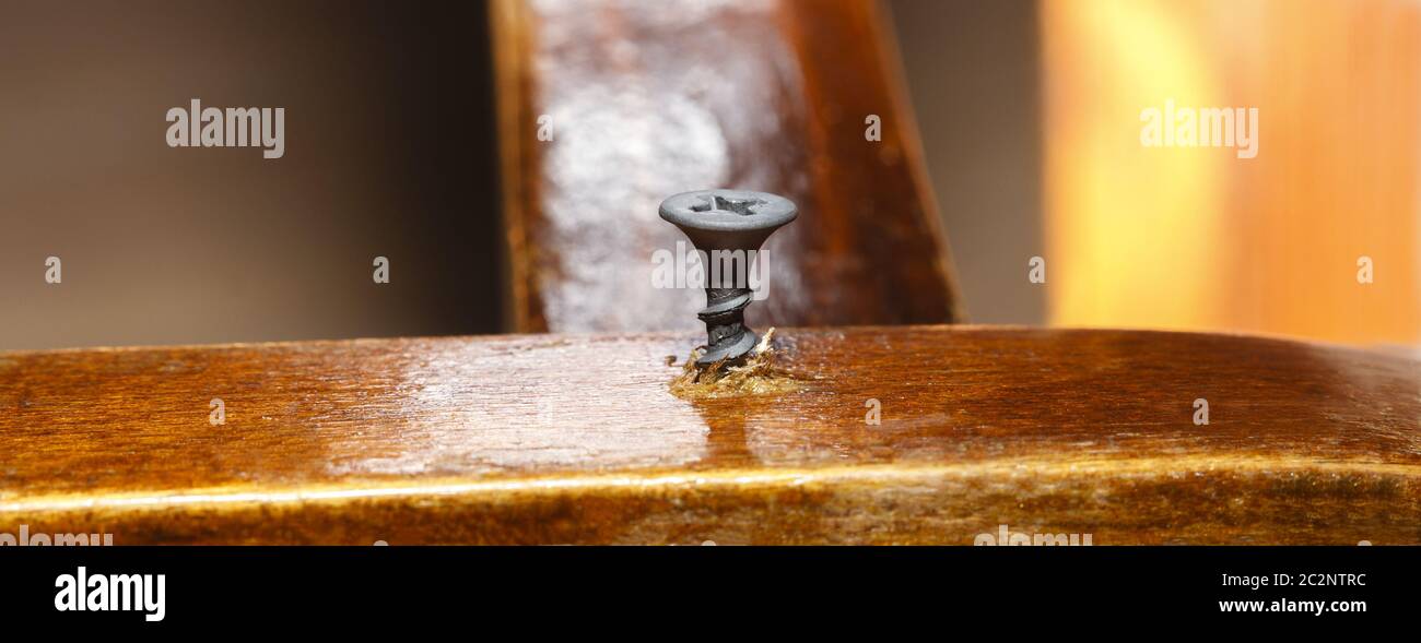 Screw in the board Stock Photo - Alamy