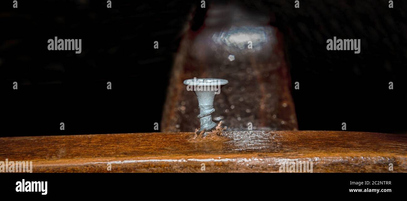 Screw in the board Stock Photo - Alamy