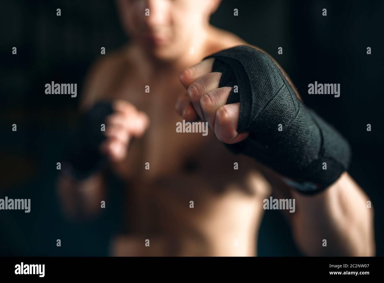 Muscular male person in black bandages. Boxing workout, mens sport ...