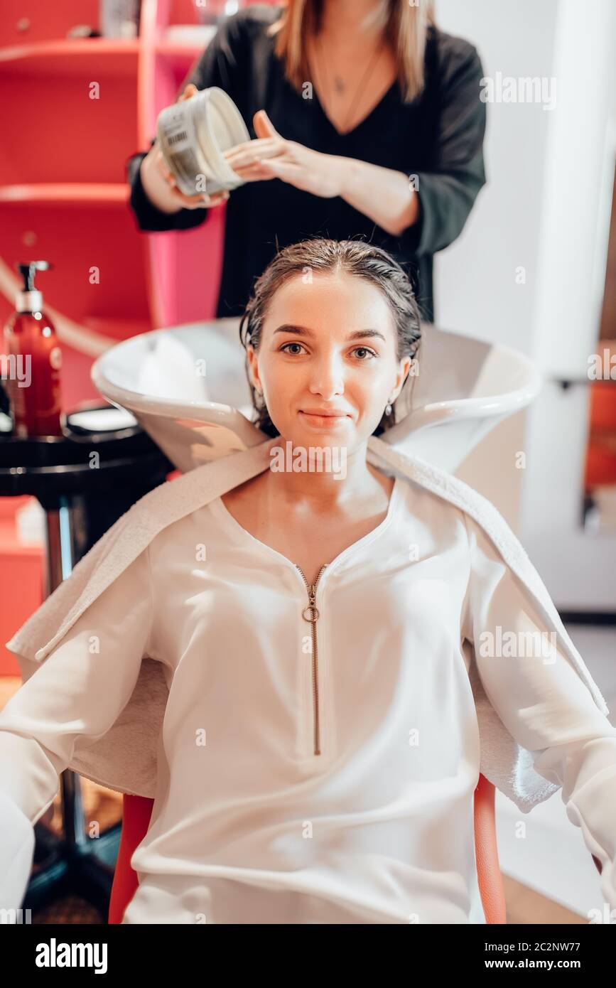 Hairdresser and customer, hair coloring process, hairdressing salon ...