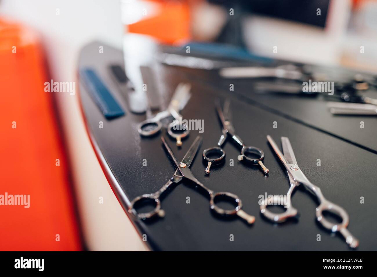 Scissors on wooden table with mirror in hairdressing salon ...