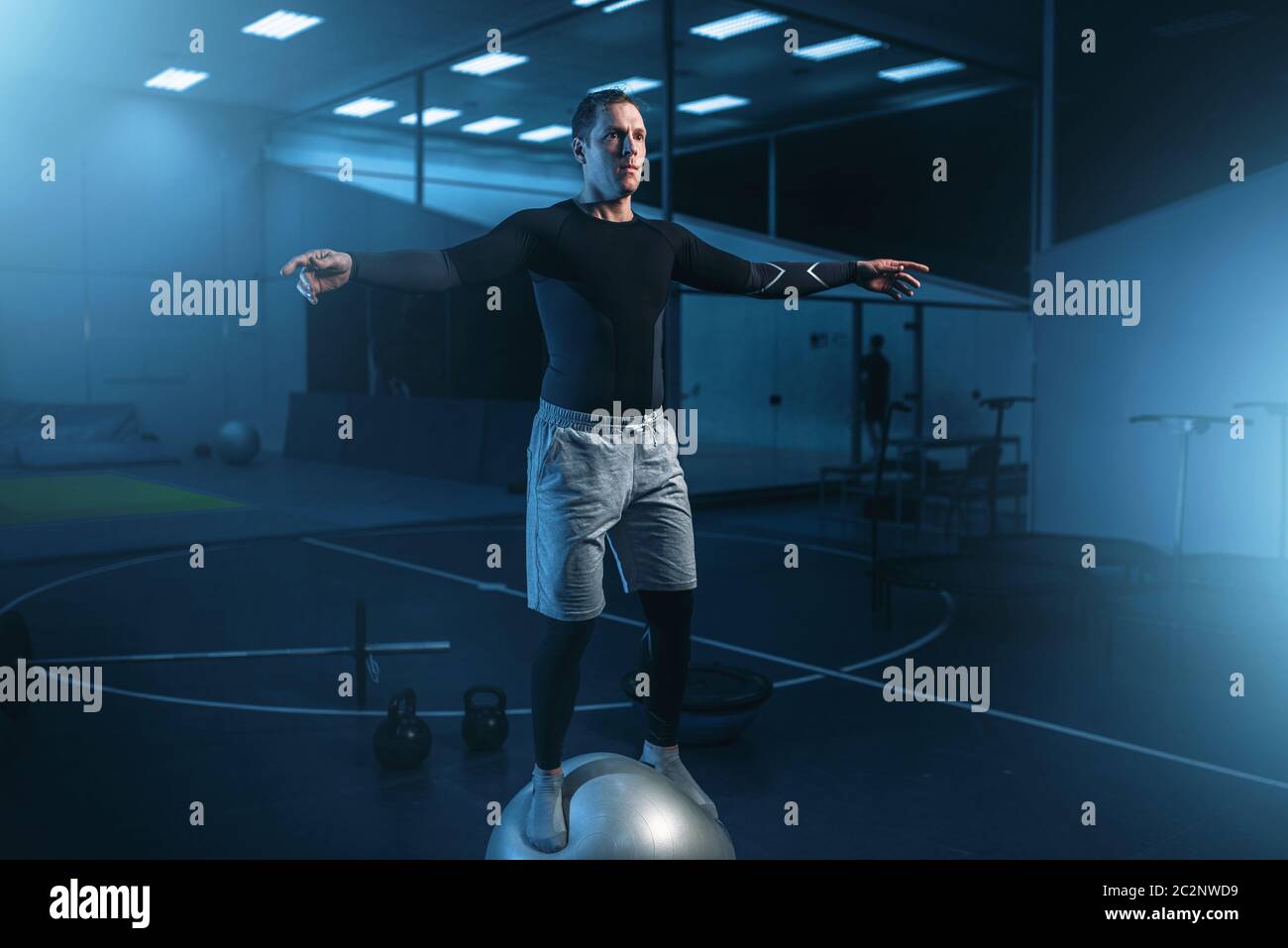 Strong man on training, balance workout with bouncy ball in gym. Active ...