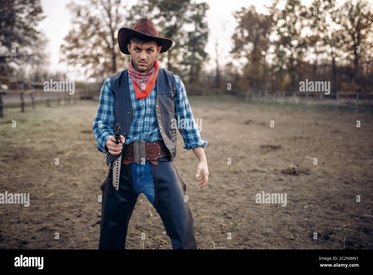 Cowboy with revolver makes quick shot, gunfight on texas ranch, western ...