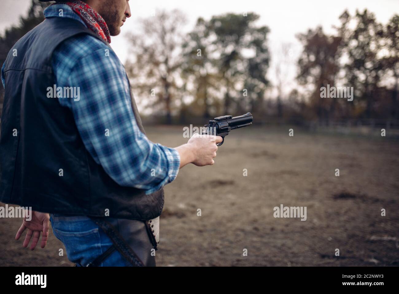 Cowboy with revolver, front view, gunfight on texas ranch, western ...