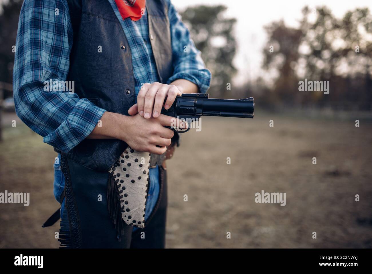 Cowboy with revolver makes quick shot, gunfight on texas ranch, western ...