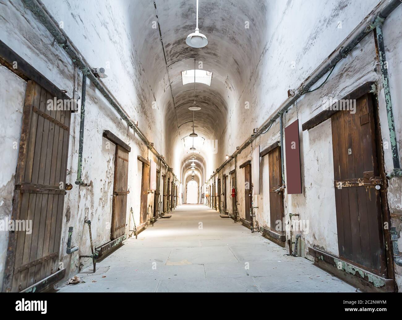 Old grunge prison. Prison cells with locked wooden doors Stock Photo ...