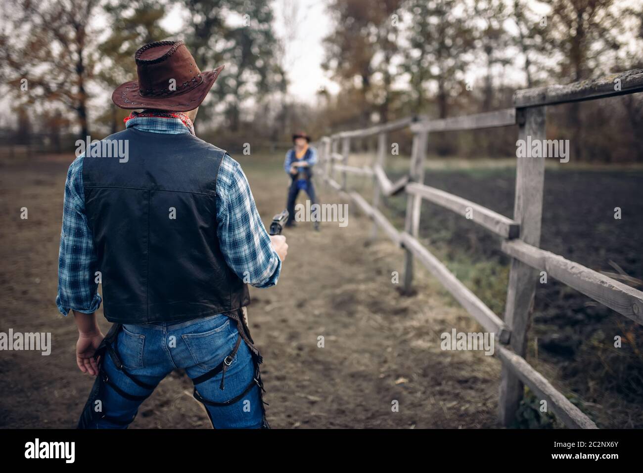 Cowboy with gun prepares to gunfight, back view, lucky strike on texas ...
