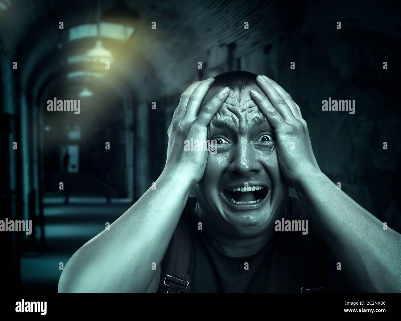 Very scared man in the dark corridor Stock Photo - Alamy