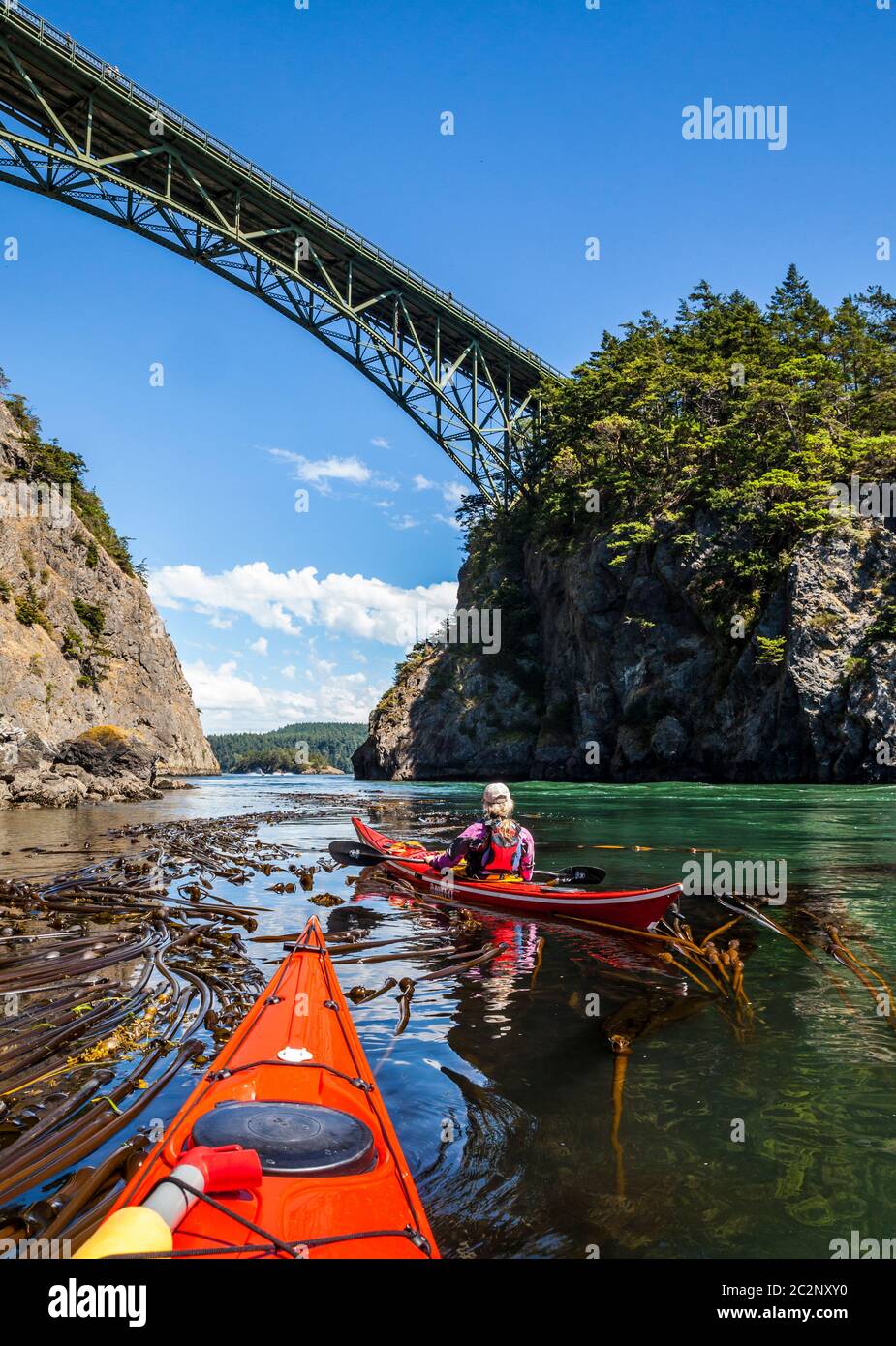 Two sea kayakers checking the flow at Canoe Pass below the Deception ...