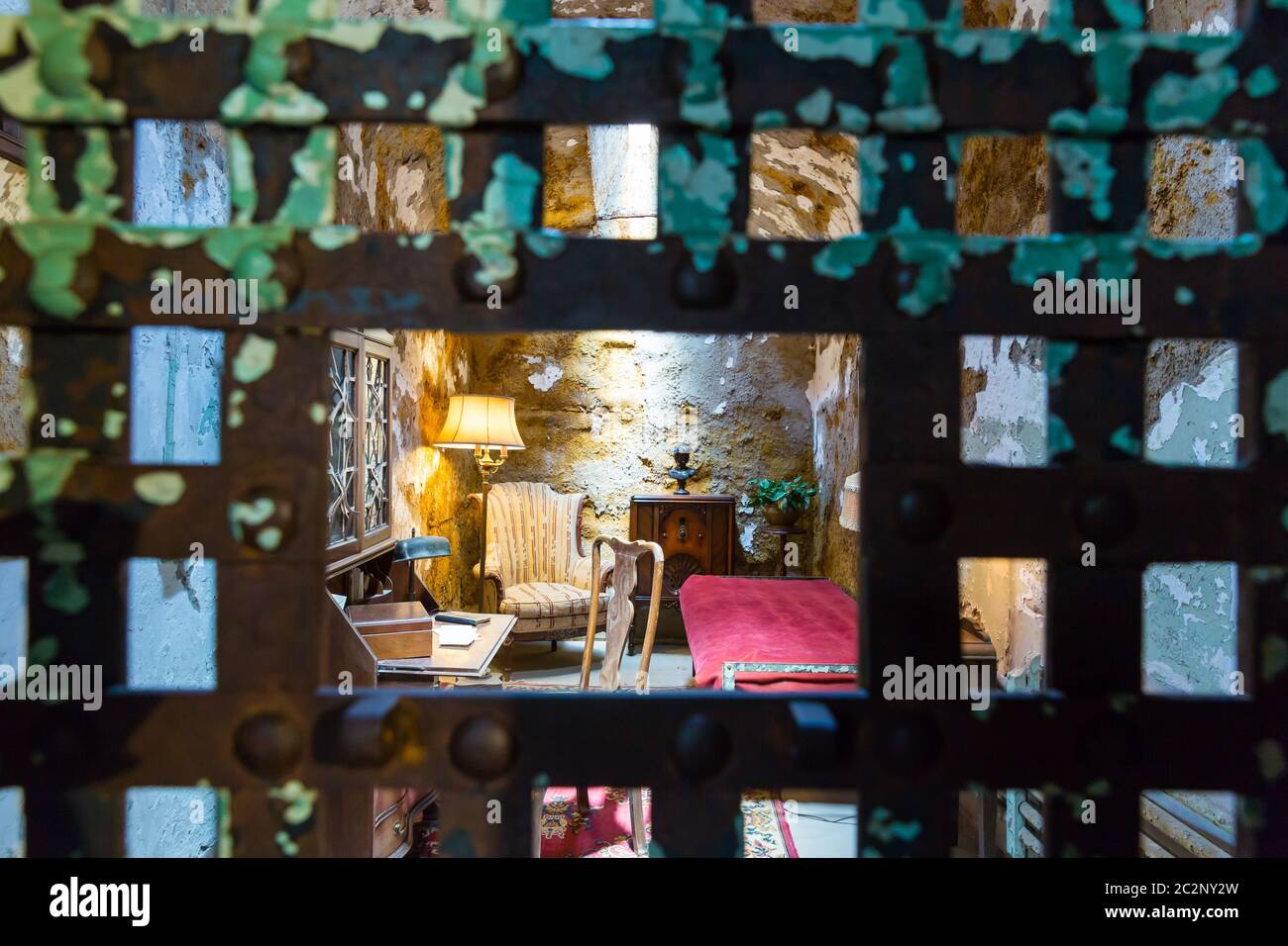 Rusty metal bar door and furnitured prison cell. Inside old jail Stock ...