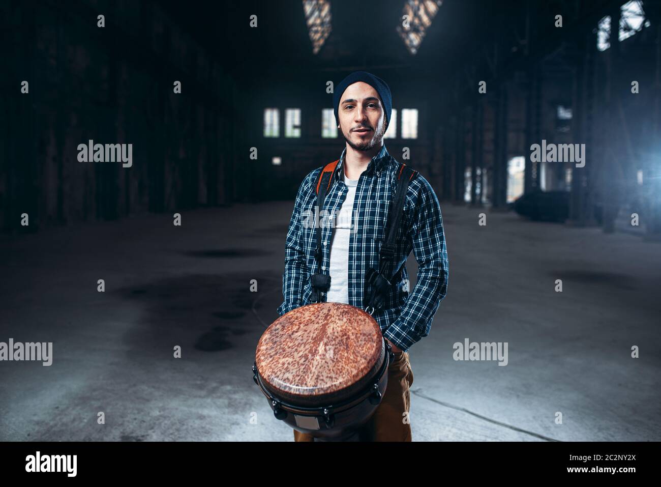 Male drummer playing on wooden drum, musician in motion. Bongo, musical ...