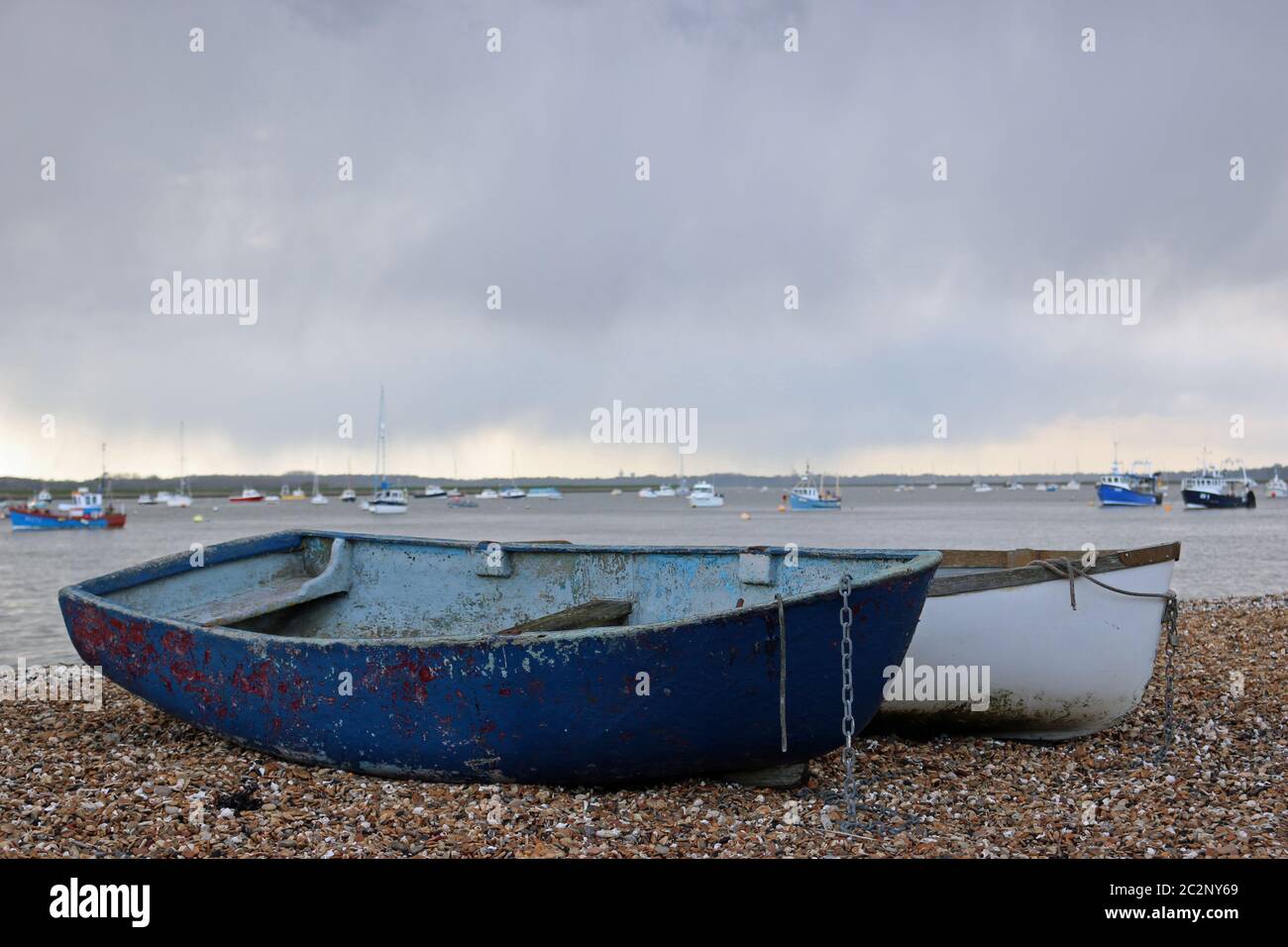 Two rowing boats used to get sailors to their boats hauled up on a ...