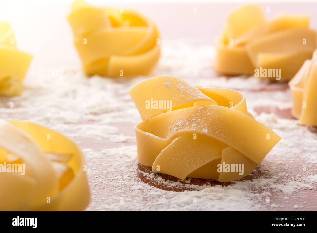 Pasta rolls on the floured table Stock Photo - Alamy