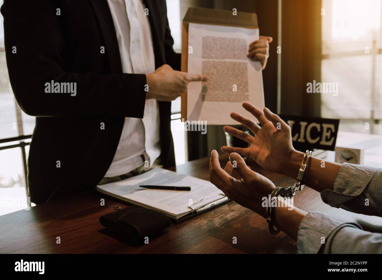 The police officer pointed to the document requesting the arrest of the ...