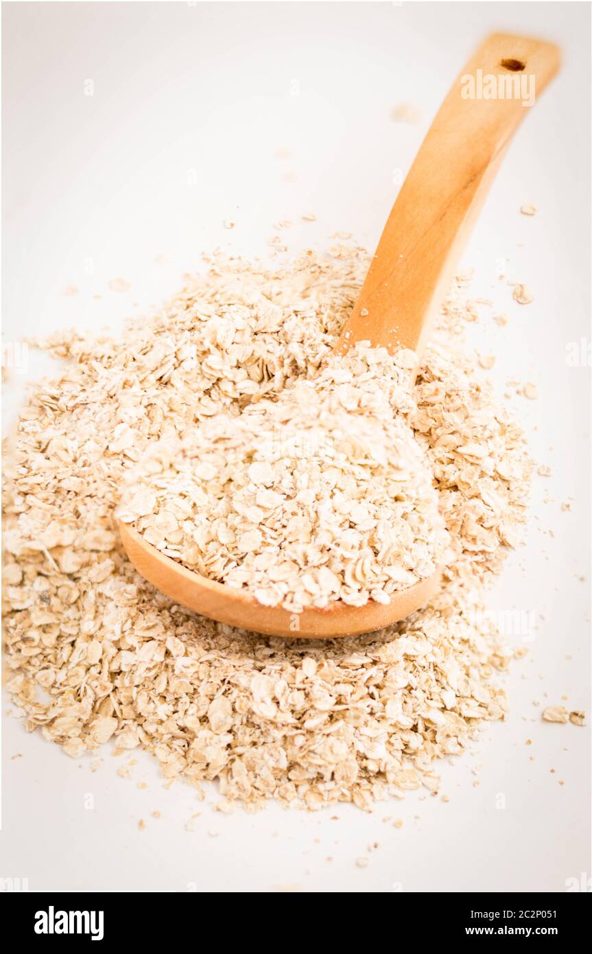 oatmeal in a wooden spoon on white background Stock Photo - Alamy