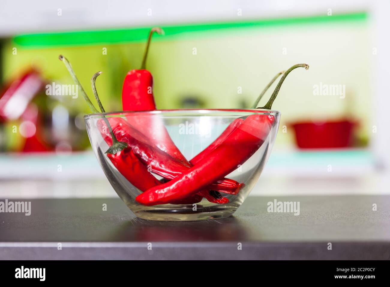 Pods of pepper in glass plate in the kitchen Stock Photo - Alamy