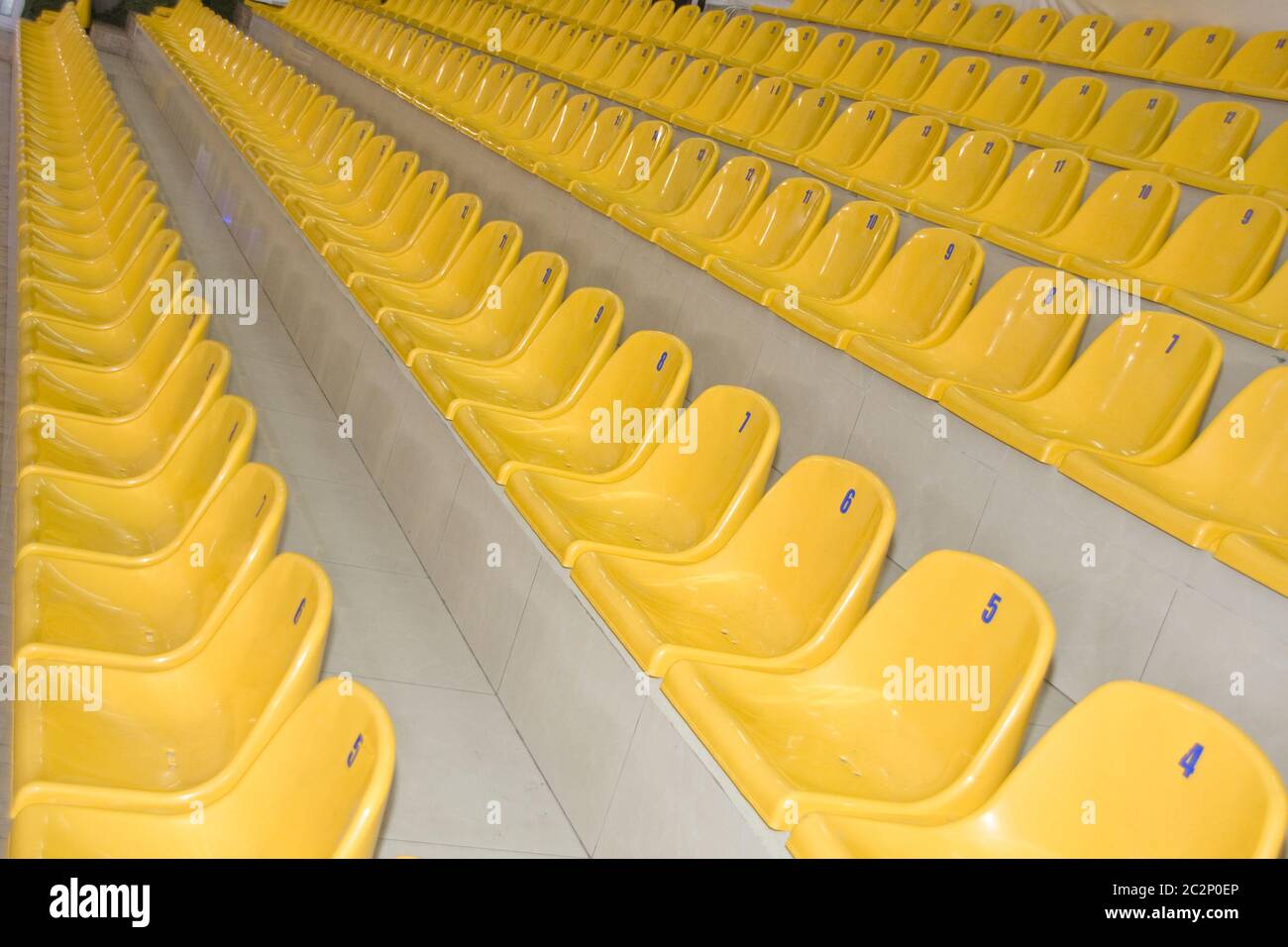 Rows of yellow seats Stock Photo - Alamy