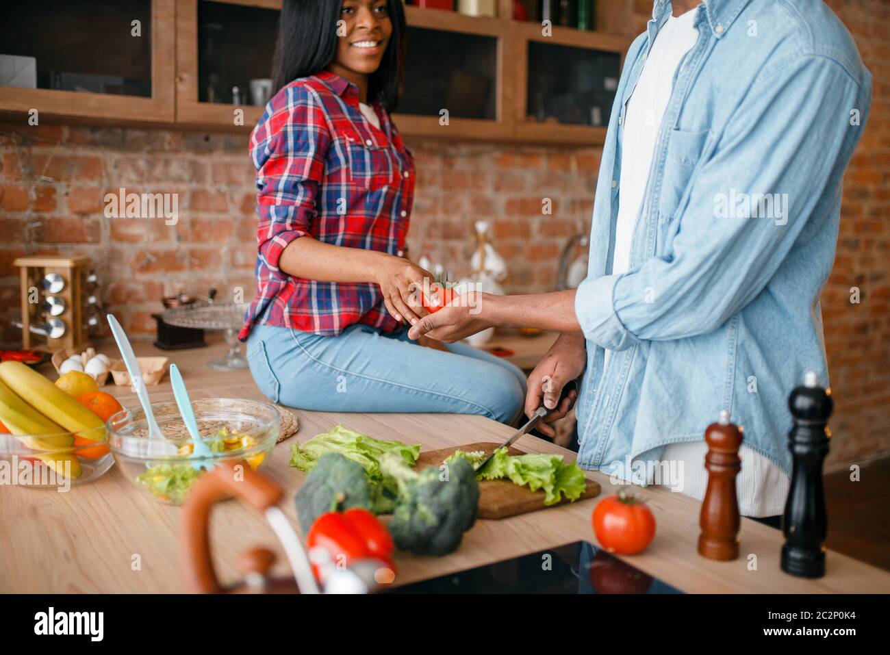 Black couple cooking together on the kitchen. African family preparing ...