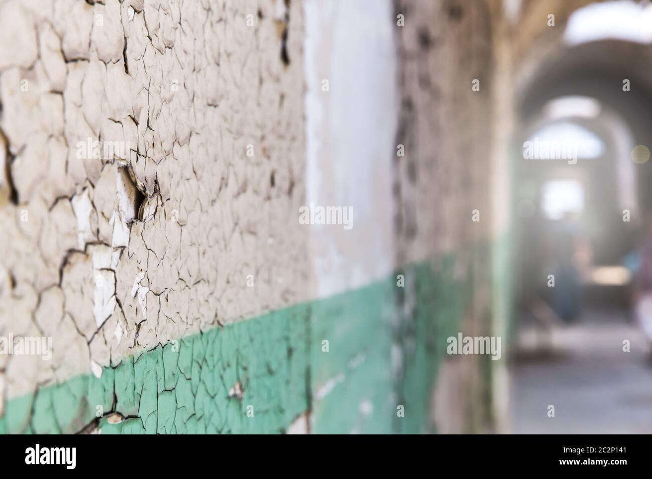 Grunge corridor wall with burst paint in old prison. Old jail interior ...