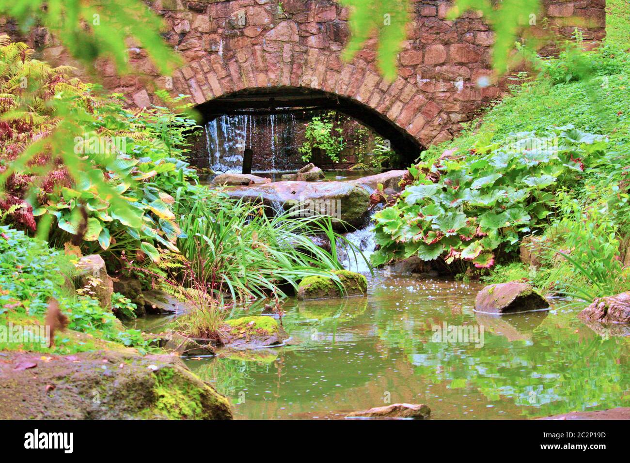 small river with stone bridge in a park Stock Photo - Alamy
