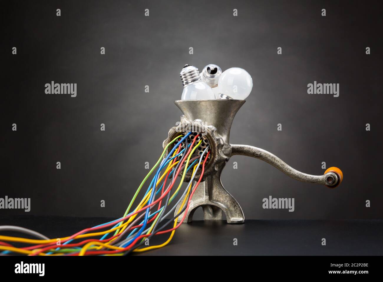 Mincing machine is grinding up light bulbs to cables Stock Photo - Alamy