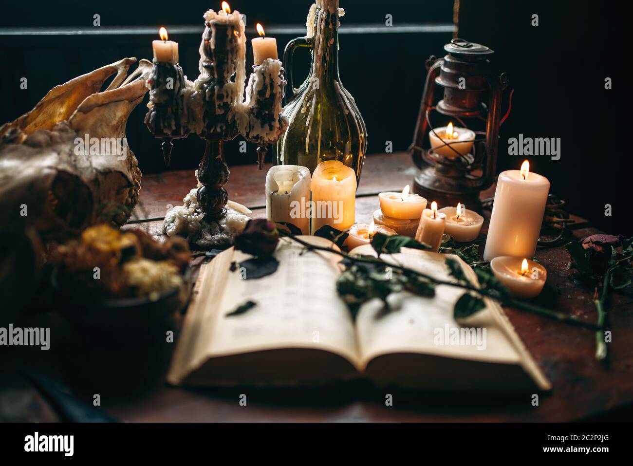 Witchcraft, dark magic, candles with ritual book on the table, nobody ...
