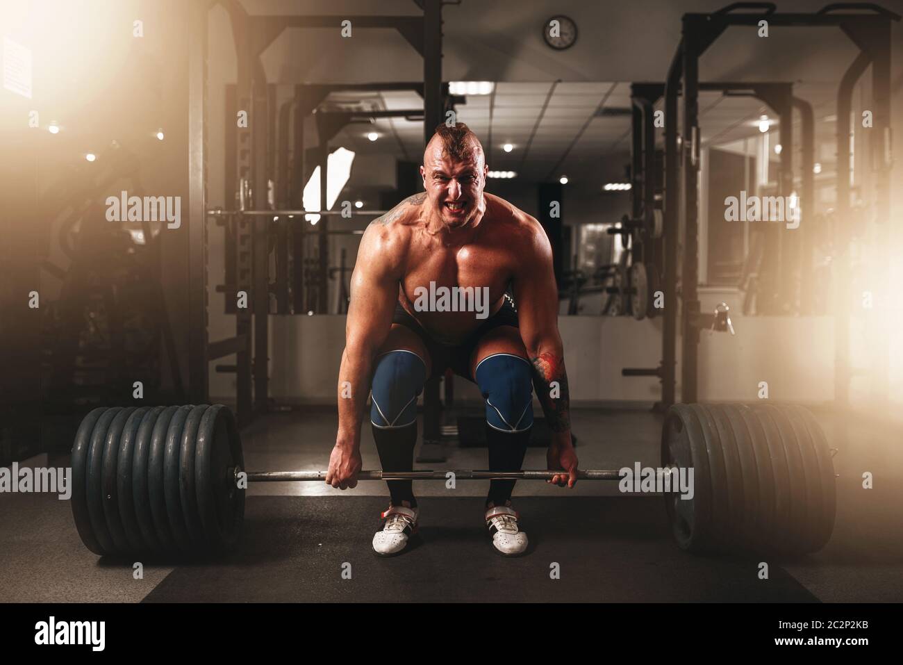 Strong male bodybuilder lifting the weight. Exercise with barbell in ...