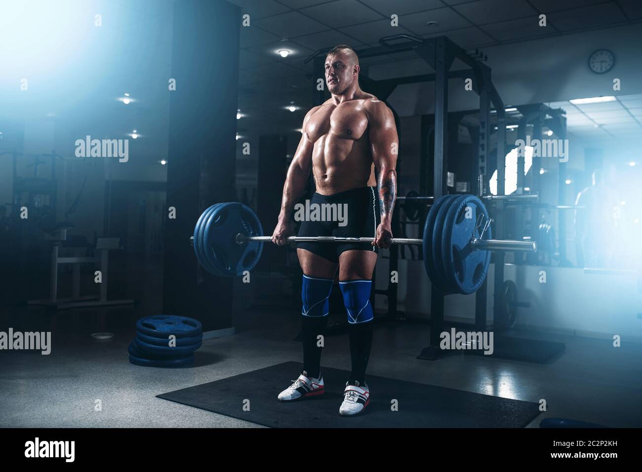 Strong athlete exercise with weight in fit gym. Fitness training with ...